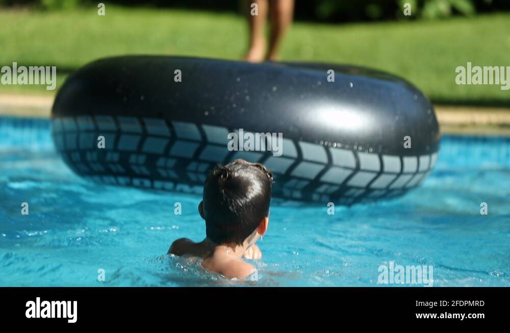 Boys having fun at the pool, child running and diving into pool water ...