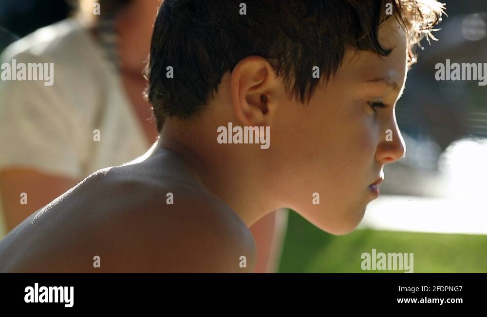 Contemplative young boy thinking deeply. Candid profile of pensive ...