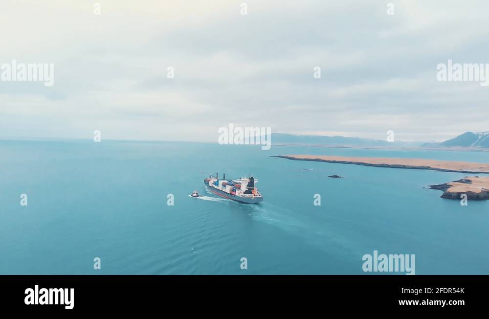 Birds eye view of cargo vessel sailing alone on the blue waters of the ...