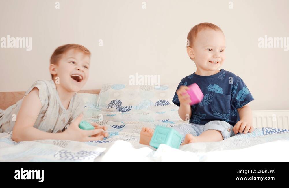 Two happy kids playing and learning. Small brothers having fun together ...