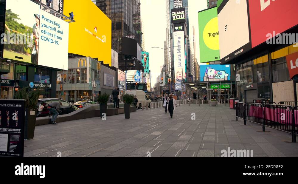 Two Medical Professionals Walk Through A Nearly Empty Times Square, New ...
