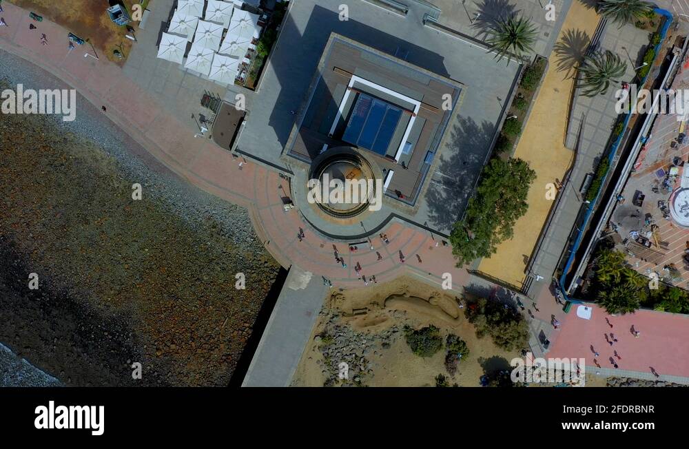 Rotating aerial view of a tall tower near the beach. Bird view of a ...