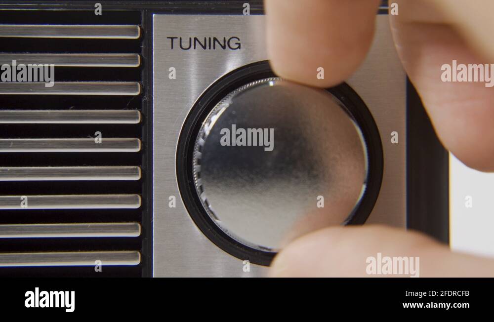 Extreme close up tuning radio frequency stations on retro transistor ...