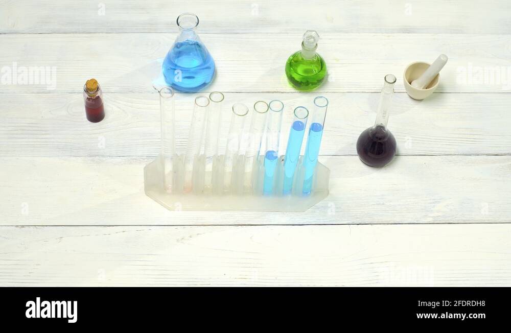 scientist dropping the reagent into test tube for reaction testing in ...