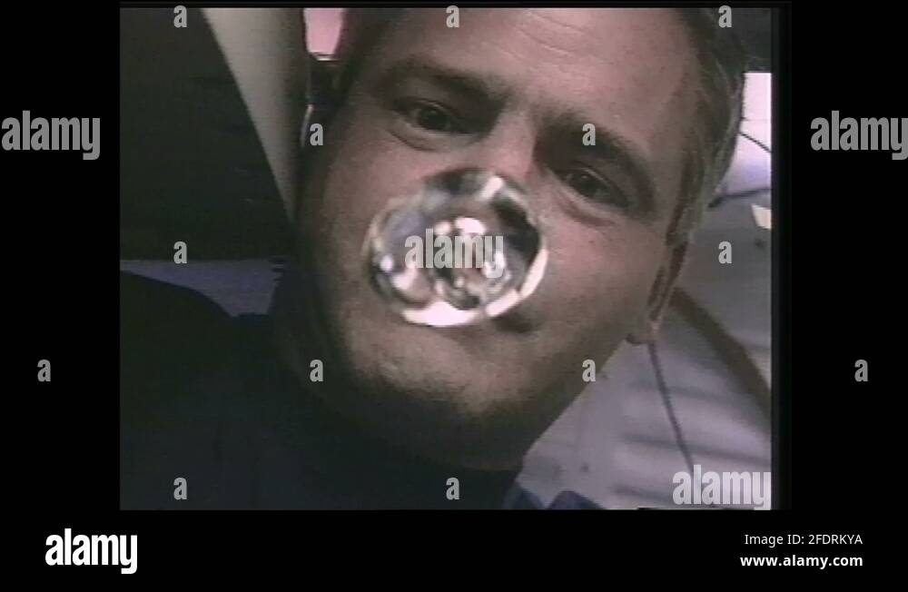 1990s: Space shuttle, man looks at sphere of water floating, rolls ...