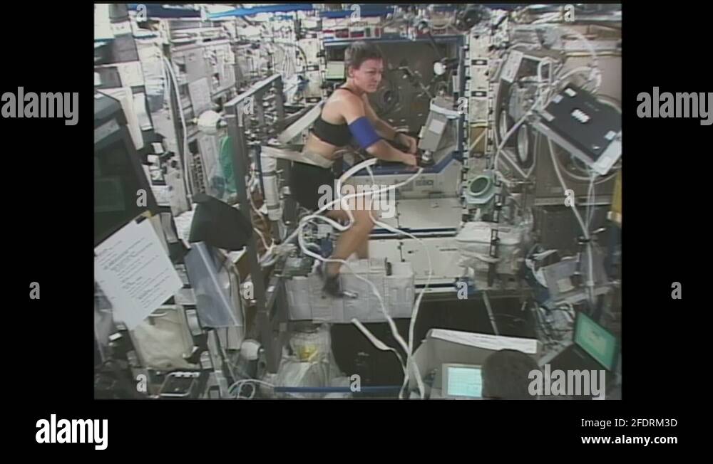 1990s: female astronaut in zero gravity pedals cycling machine, lab ...