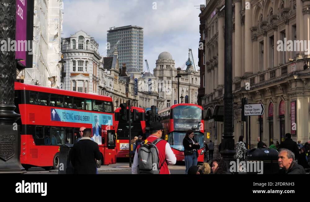 Iconic english red double-decker buses on a busy street in the center ...