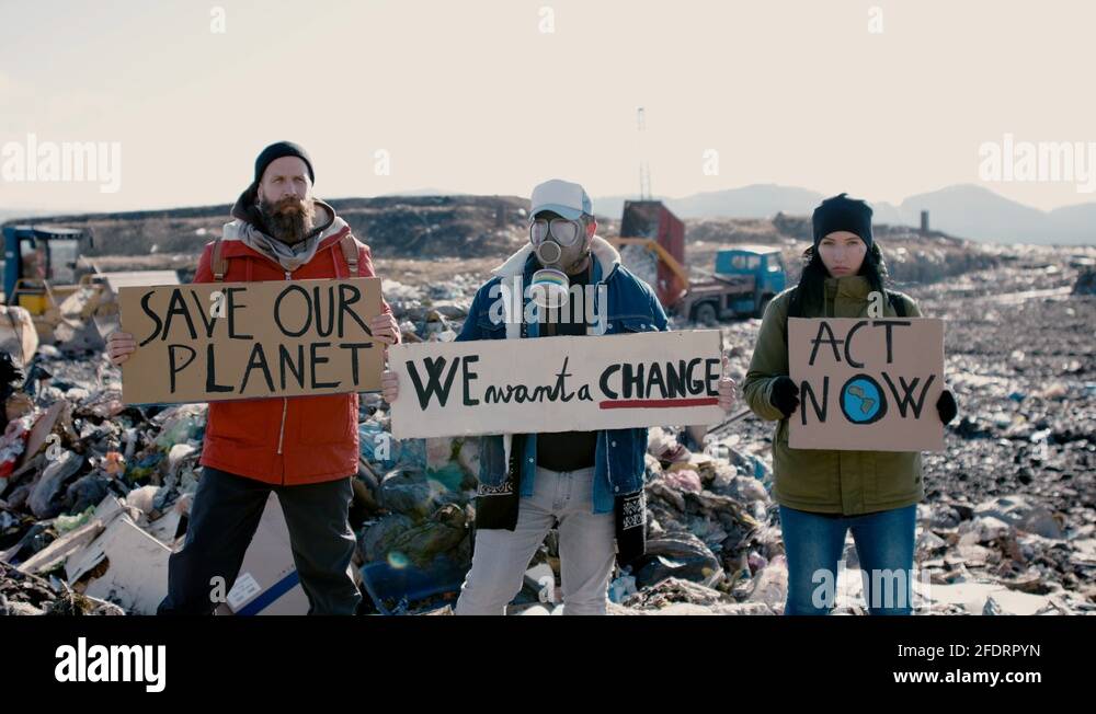 Group of activists with placard posters on landfill, environmental ...
