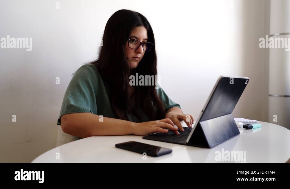New normal: a girl teleworking receives an incoming call from one of ...