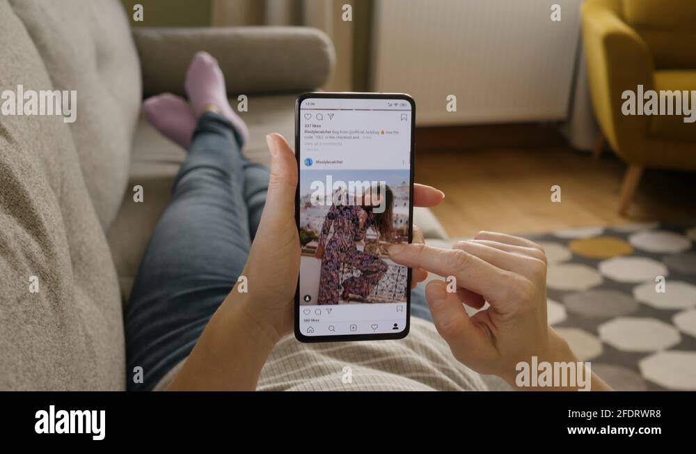 Girl Looks Instagram Page On Mobile Phone. Woman Browsing Fashion ...