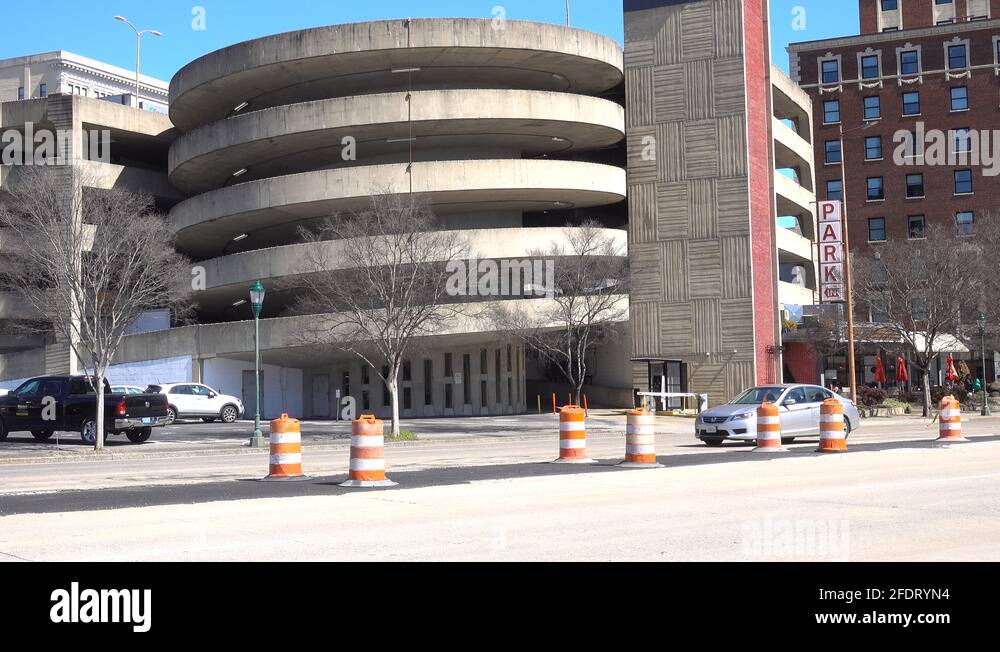 Traffic Driving By Circular Parking Garage With Construction Pylons On ...