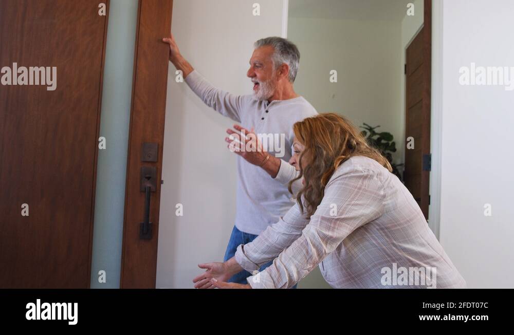 Grandparents Greeting Family At Front Door As They Comes To Visit Stock ...