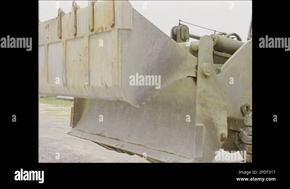 2000s: Front end loader opens bucket. Parts of machine Stock Video ...