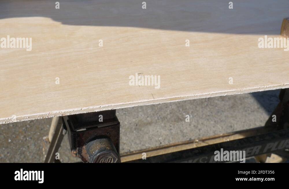 A Carpenter Drawing Lines On A Plywood With A Pencil And Steel Ruler ...