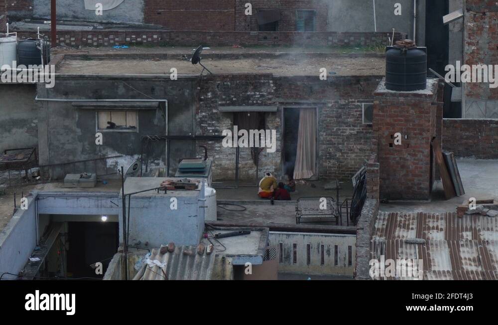 Indian Woman Cooking Over Open Fire On House Rooftop of Slum Stock ...
