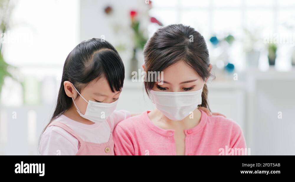 Mom and daughter wear mask Stock Video Footage - Alamy