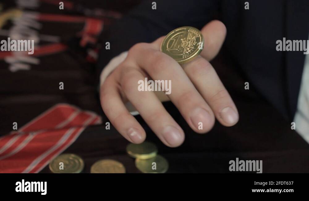a man hand is sorting a gold coin between fingers Stock Video Footage ...