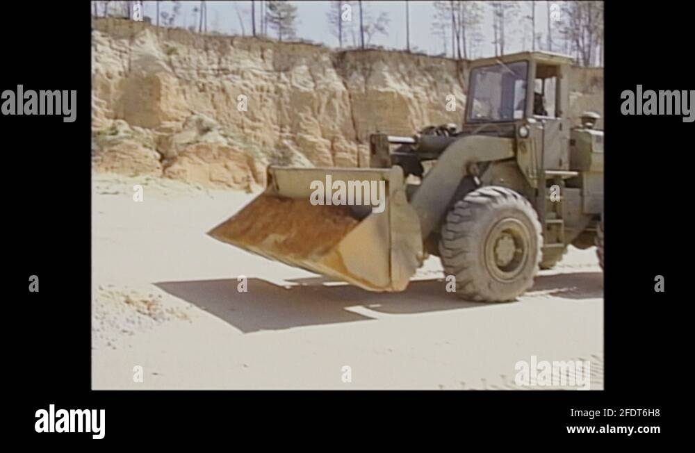 2000s: Pit. Front end loader fills in ditch with dirt Stock Video ...