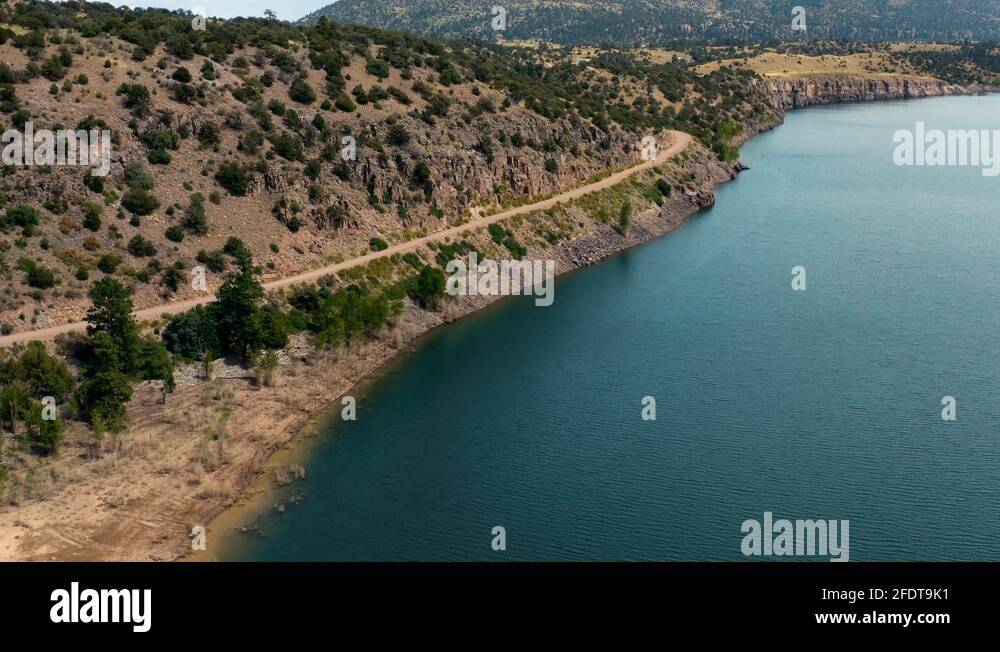 Serene backcountry river flyover with mountain backdrop Stock Video ...