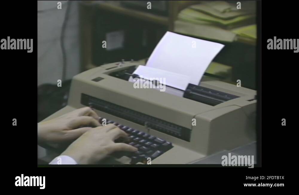1980s: Person types on word processor. Header text on message Stock ...