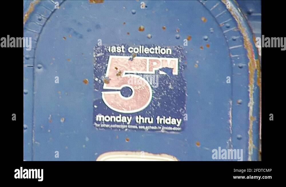 1990s: Metal mailbox in warehouse. Police officer draws pistol from ...