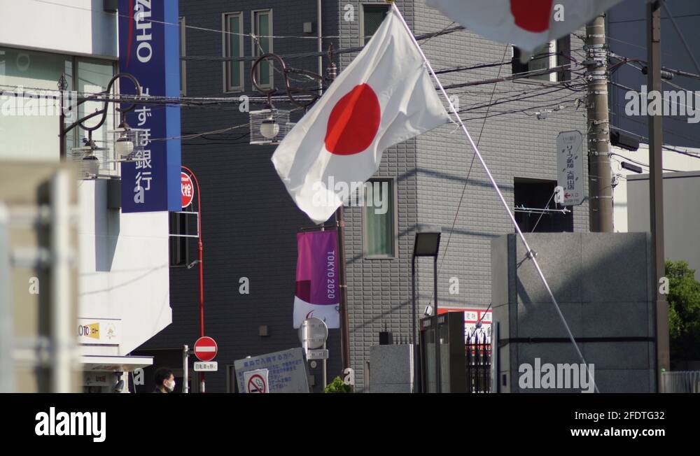 Japanese Flags Flying In The Air With A Tokyo Olympic Flag In The Stock ...