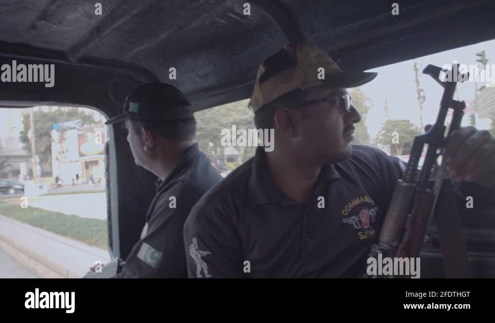 Special Police Group Commandos look alertly outside the police van in ...