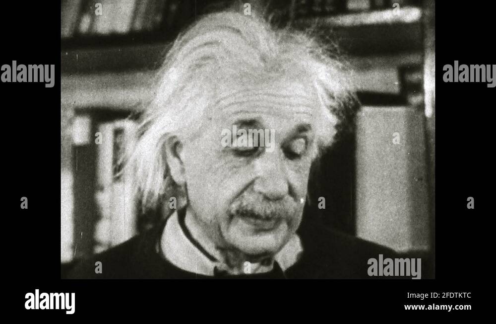 1960s: Close up of Albert Einstein talking. Einstein at desk, reading ...