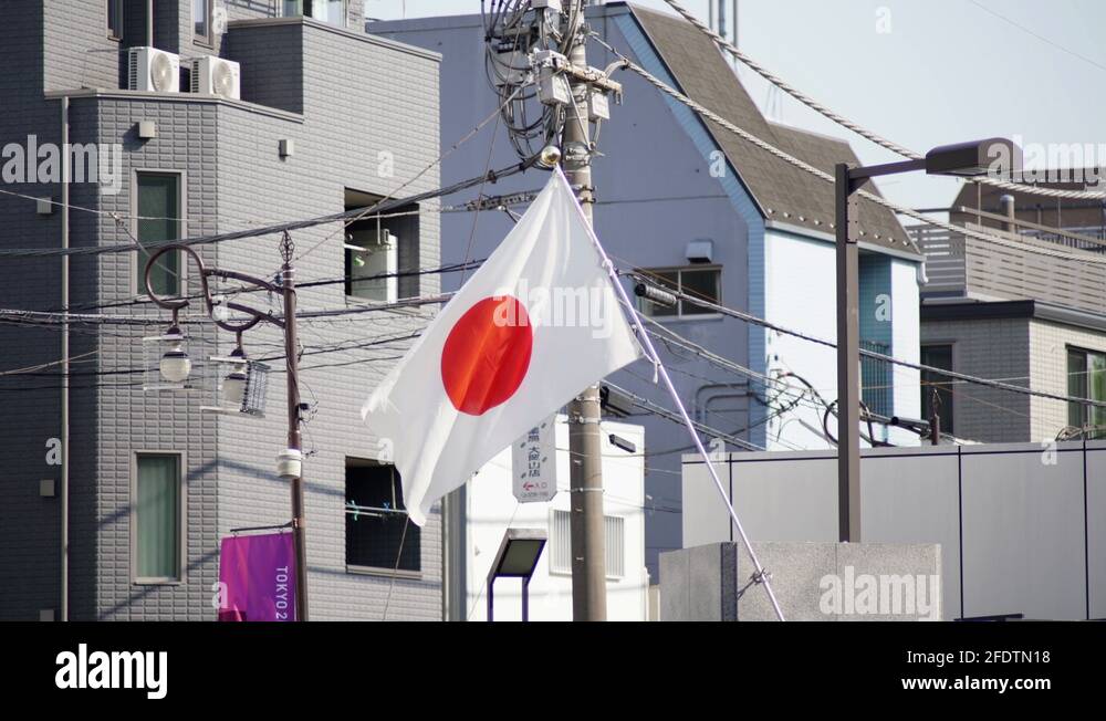 Japanese Flag Flying In The Wind Located Beside The Buildings In Tokyo ...