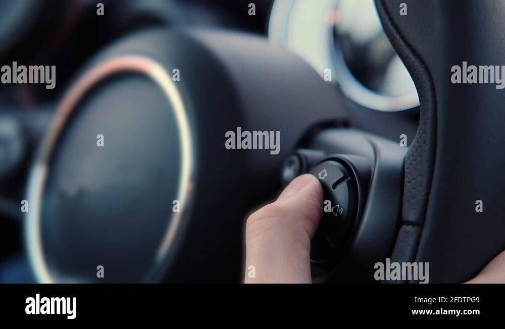 Close-up of the finger of a male driver who, with the help of shortcuts ...
