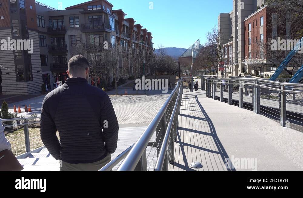People Walking About Outdoor Promenade By Built Up Residential Area ...