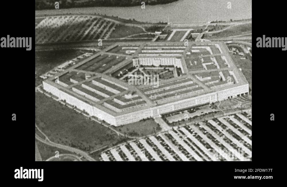 1960s: Aerial view of pentagon. People walk through doors. Crowd in ...