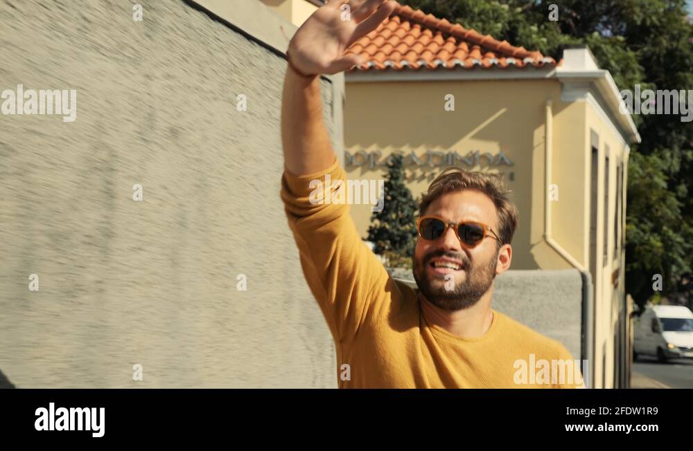 Young man running to catch the bus. Man running towards the bus stop in ...