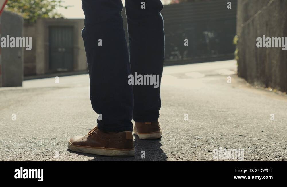 Young man running to catch the bus. Man running towards the bus stop in ...