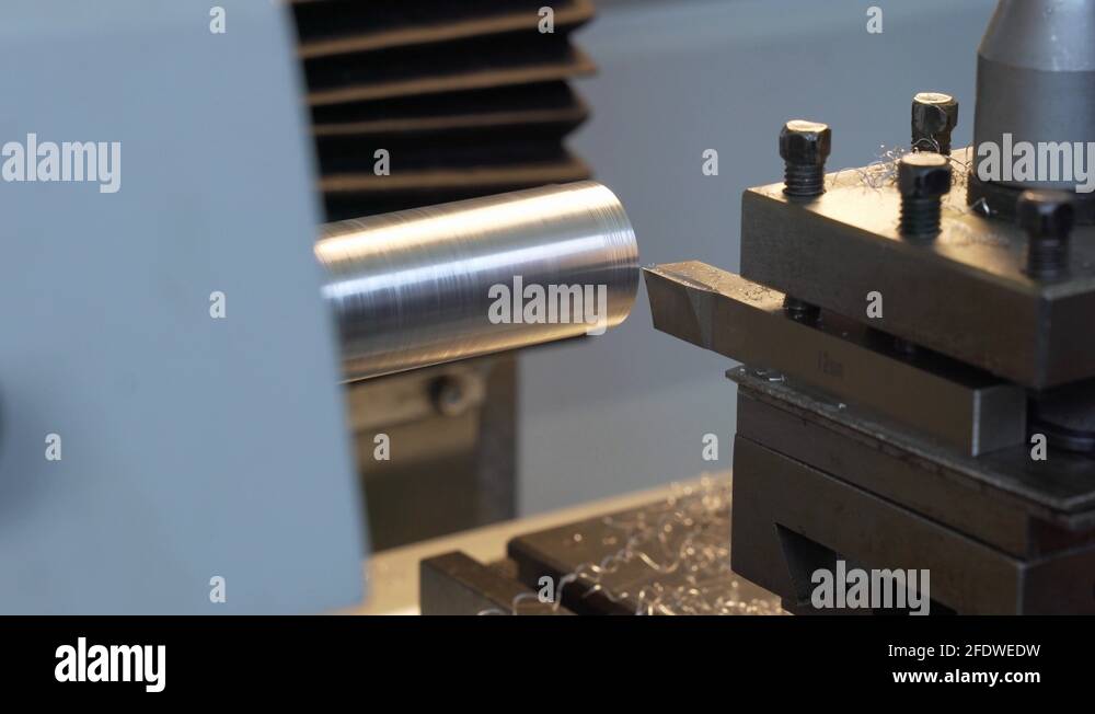 CNC Milling Machine / Lathe Procesing a Piece of Metal. Metal Particles ...
