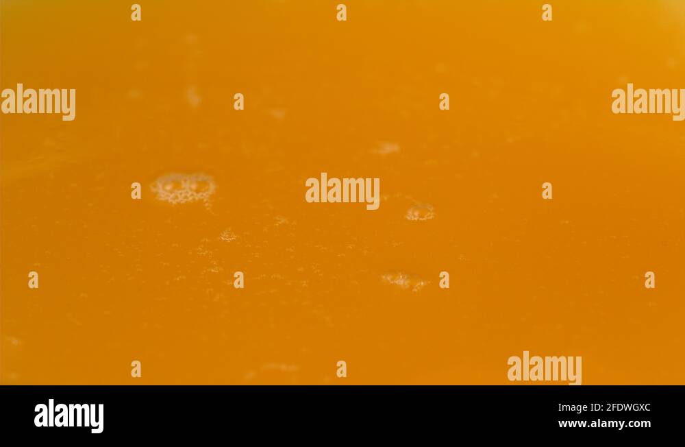 Mango chunks falling into mango juice in slow motion. Shot with Phantom ...