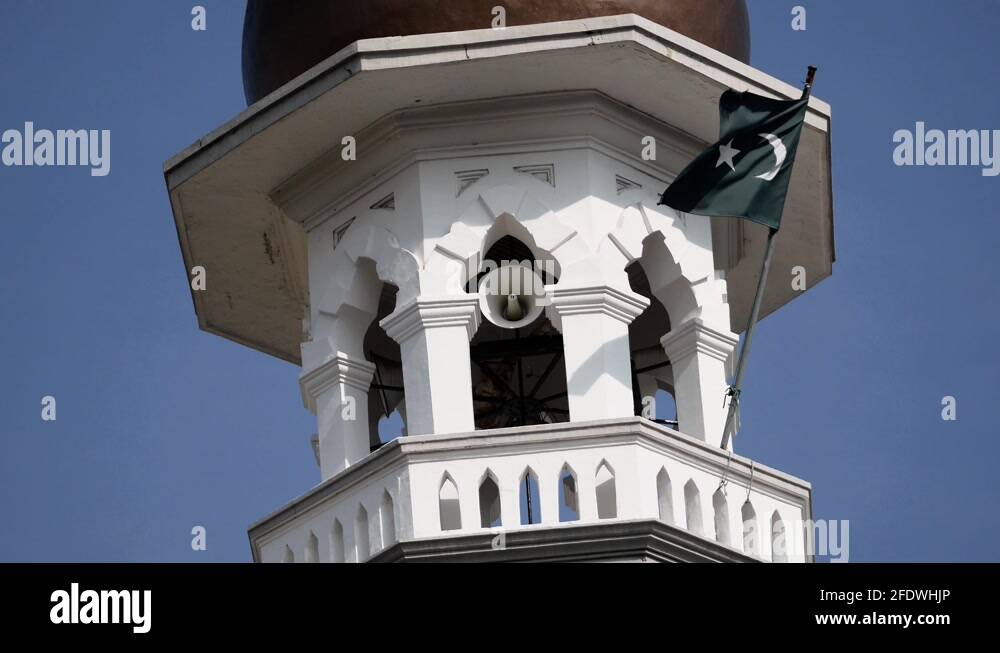 Green Star and crescent flag represent Islam. Flag on minaret Masjid ...
