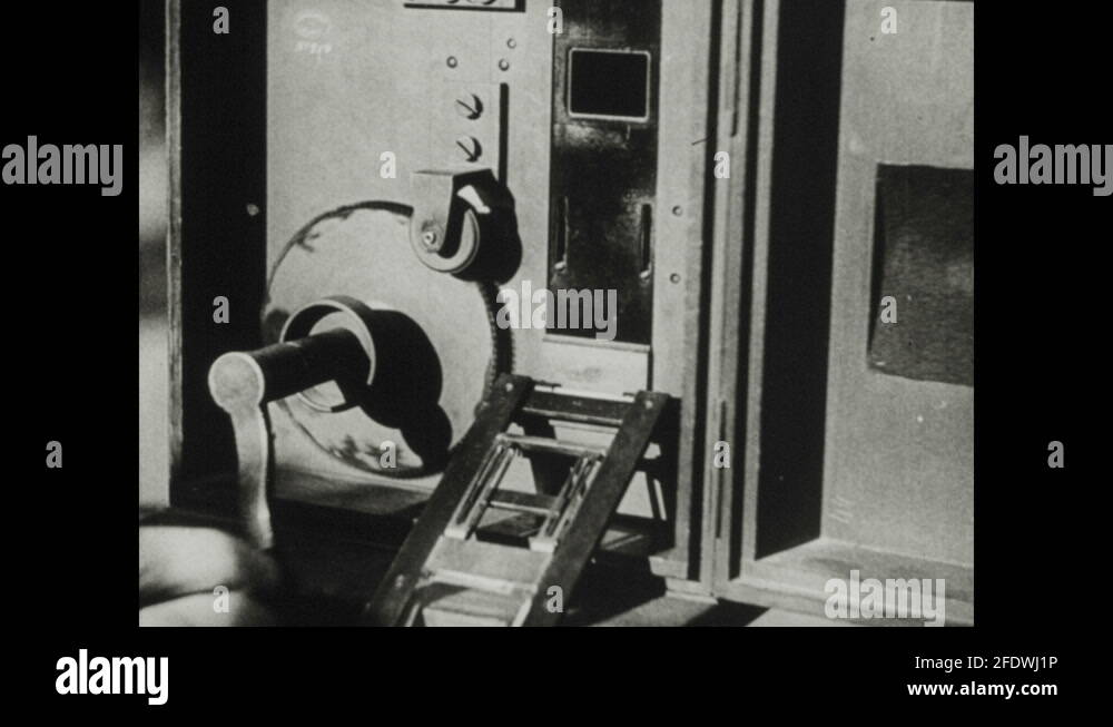 1940s: Interior of a Lumiere projector. Film is pulled through the ...