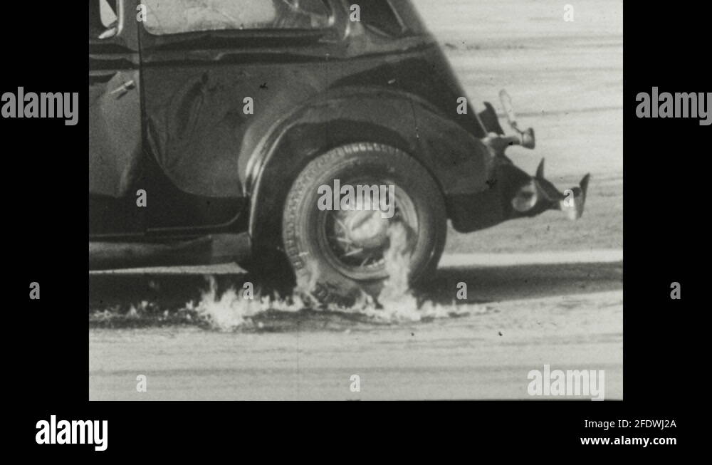 1950s: Fire breaks out from leaked gasoline around wrecked car. Car ...