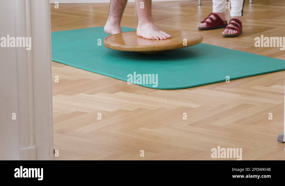 A clip of a male patient standing on a balance board during a physical ...