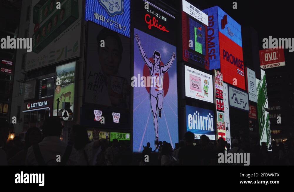 The Glico neon sign at night in Dotonburi, Osaka Japan Stock Video ...