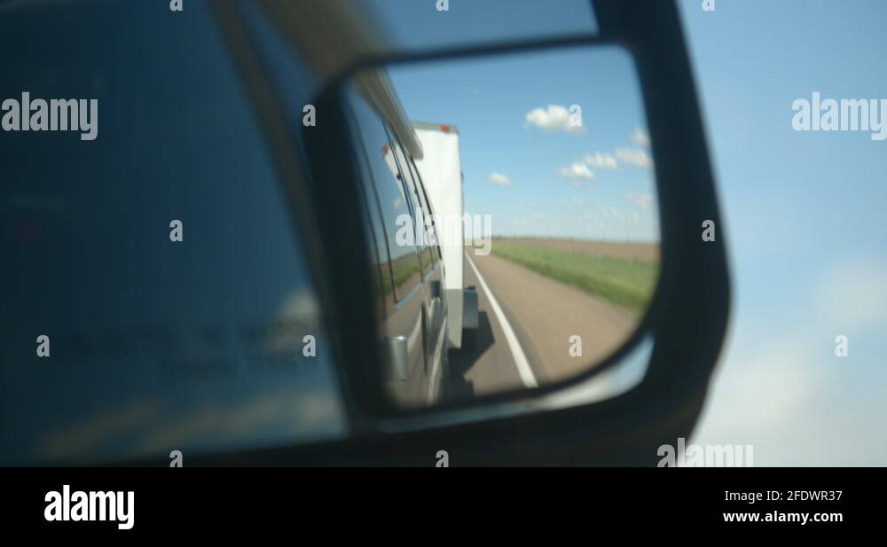 Objects in mirror are closer than they appear pulling a trailer. Focus ...
