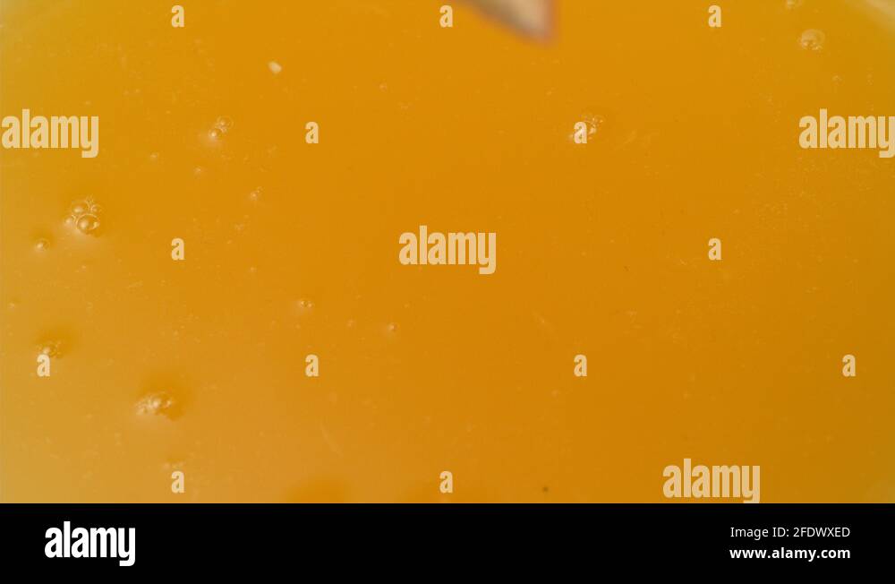Mango chunks falling into mango juice in slow motion. Shot with Phantom ...