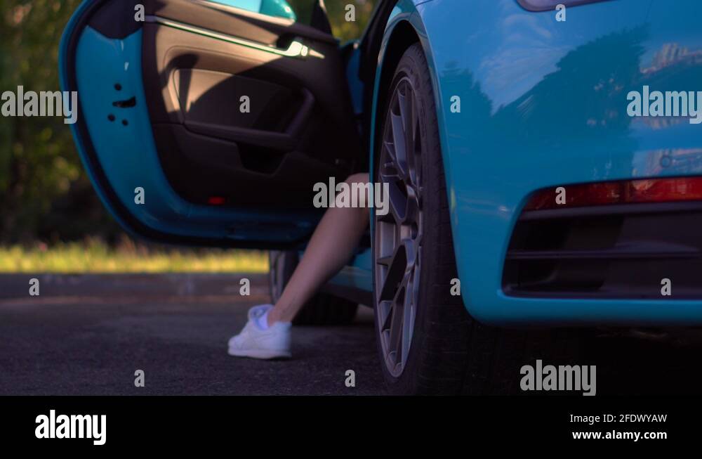 Rear wheel of the car and the driver gets in and closes the door Stock ...