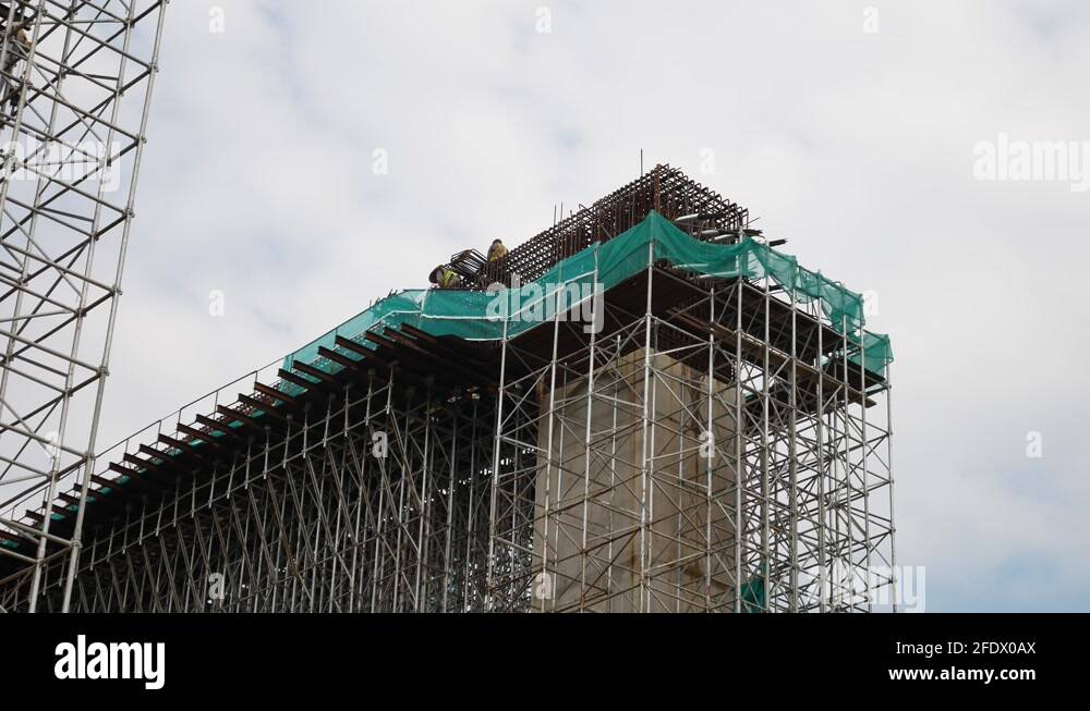 Construction workers fabricating steel reinforcement bar and installing ...