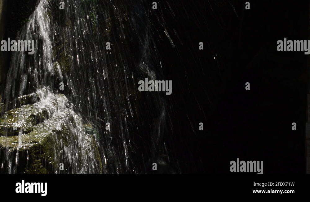 Water stream falling in waterfall in a cave Stock Video Footage - Alamy