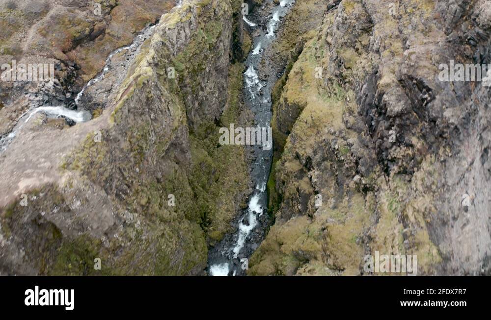 Birds eye top view of a river floating down after huge waterfall Stock ...