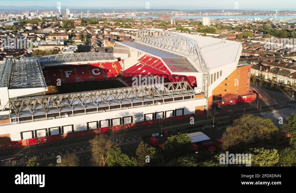 Iconic Liverpool Anfield LFC stadium football ground aerial slow orbit ...