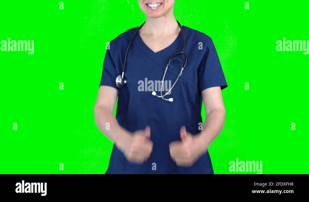 4K Nurse doctor on green screen isolated with chroma key gives thumbs ...