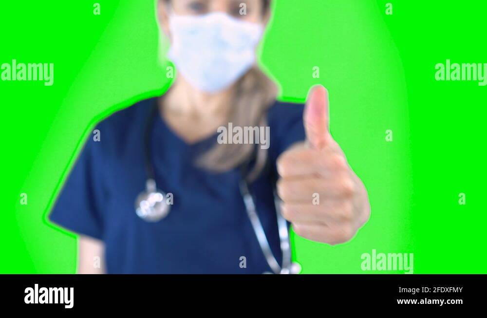 4K female nurse doctor on green screen isolated with chroma key gives ...